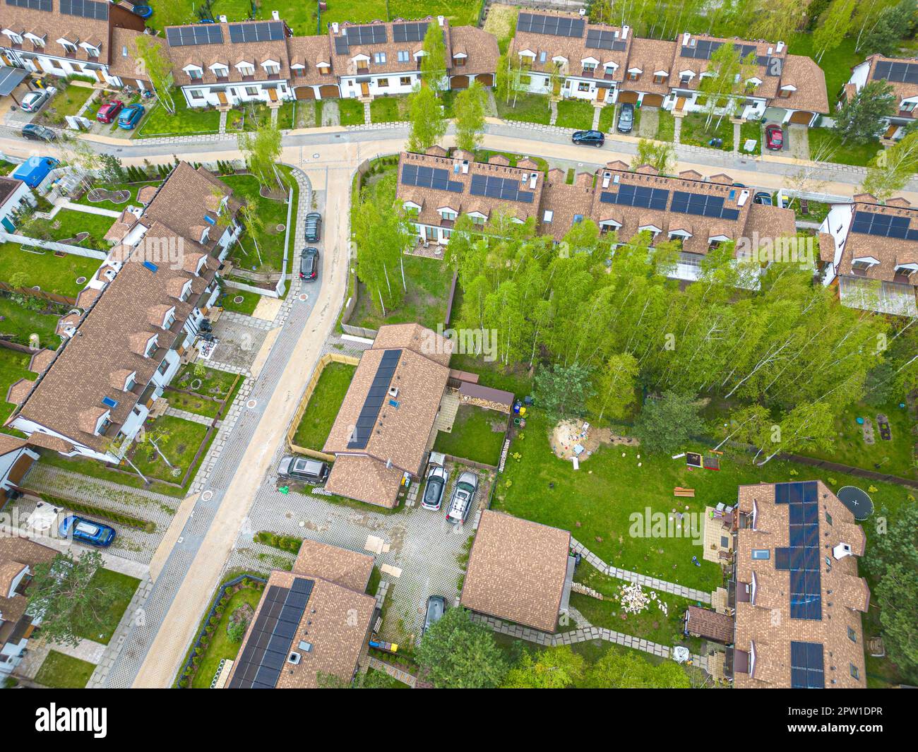 Aerial drone image of some pretty houses with solar panels on the roofs ...