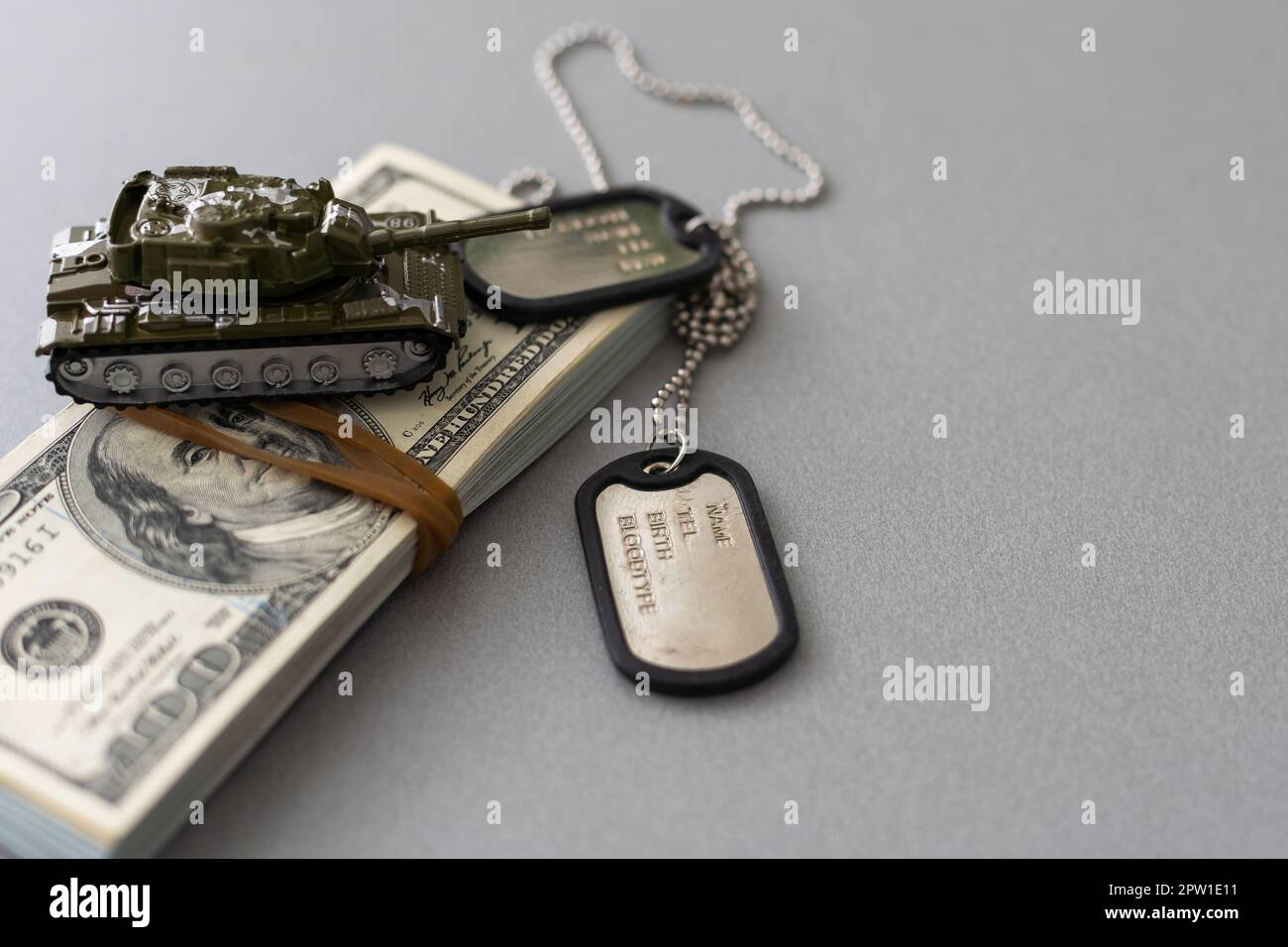 Army identification medallions and dollar bills on United states flag ...