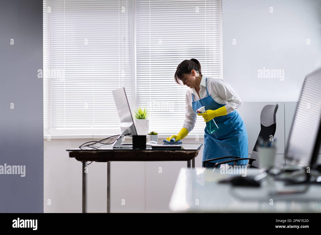 Janitor Cleaning Office Desk. Hygiene Cleaner Service Stock Photo - Alamy