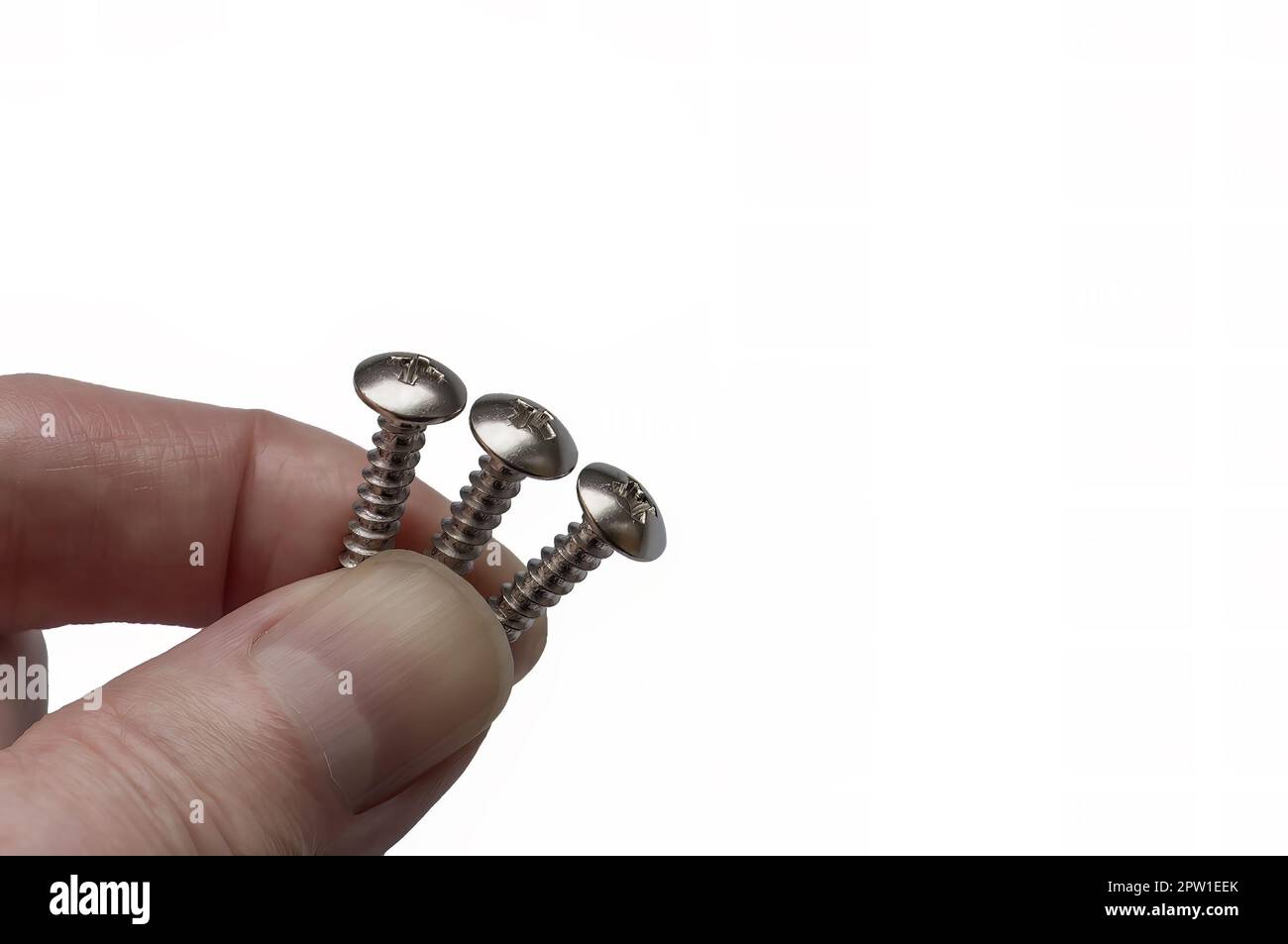 Man holding three stainless steel self-tapping screws in his hand ...