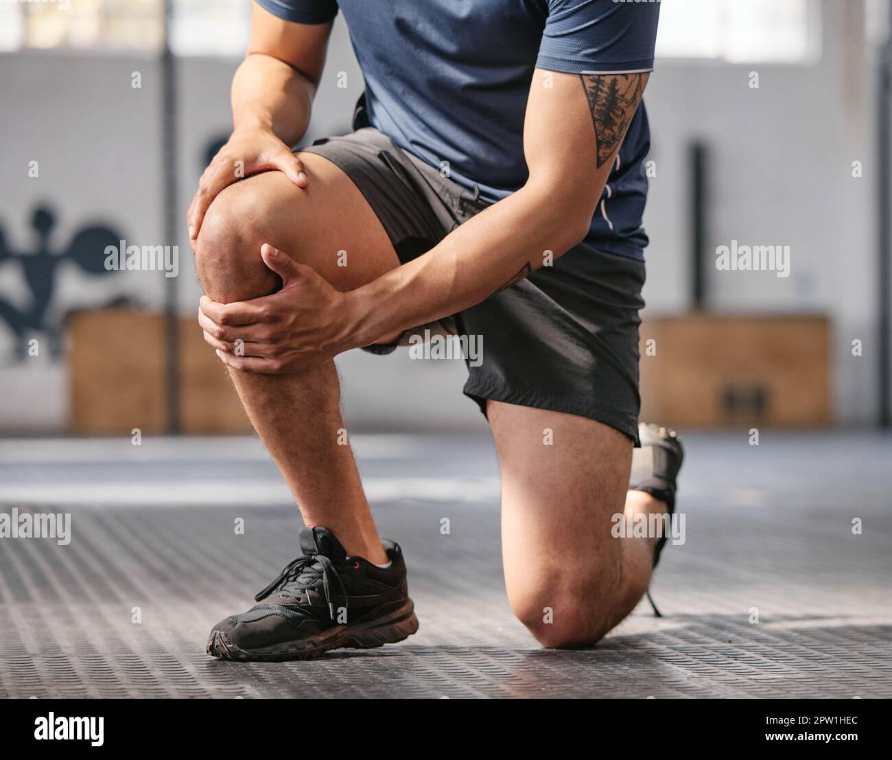 Closeup of one caucasian man holding his sore knee while exercising in ...