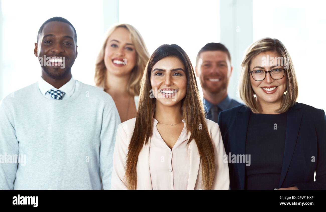 Portrait of a group of confident work colleagues standing together ...