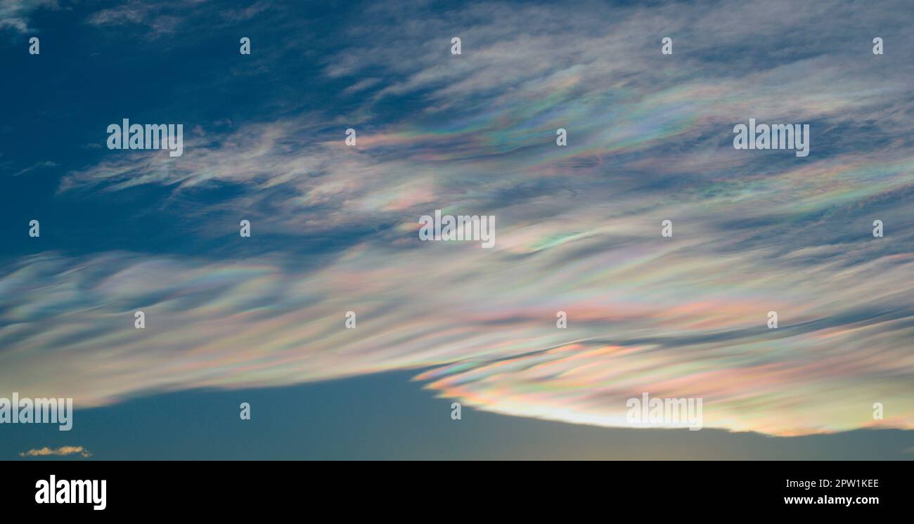 Thin wispy clouds creating rainbow patterns of scattered sunlight ...