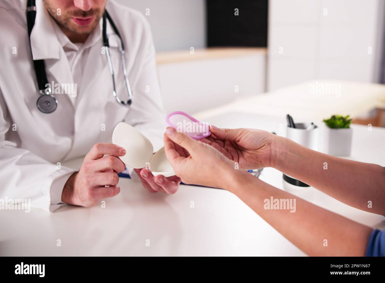 Gynecologist Showing Contraception Ring And Diaphragm To Woman And ...