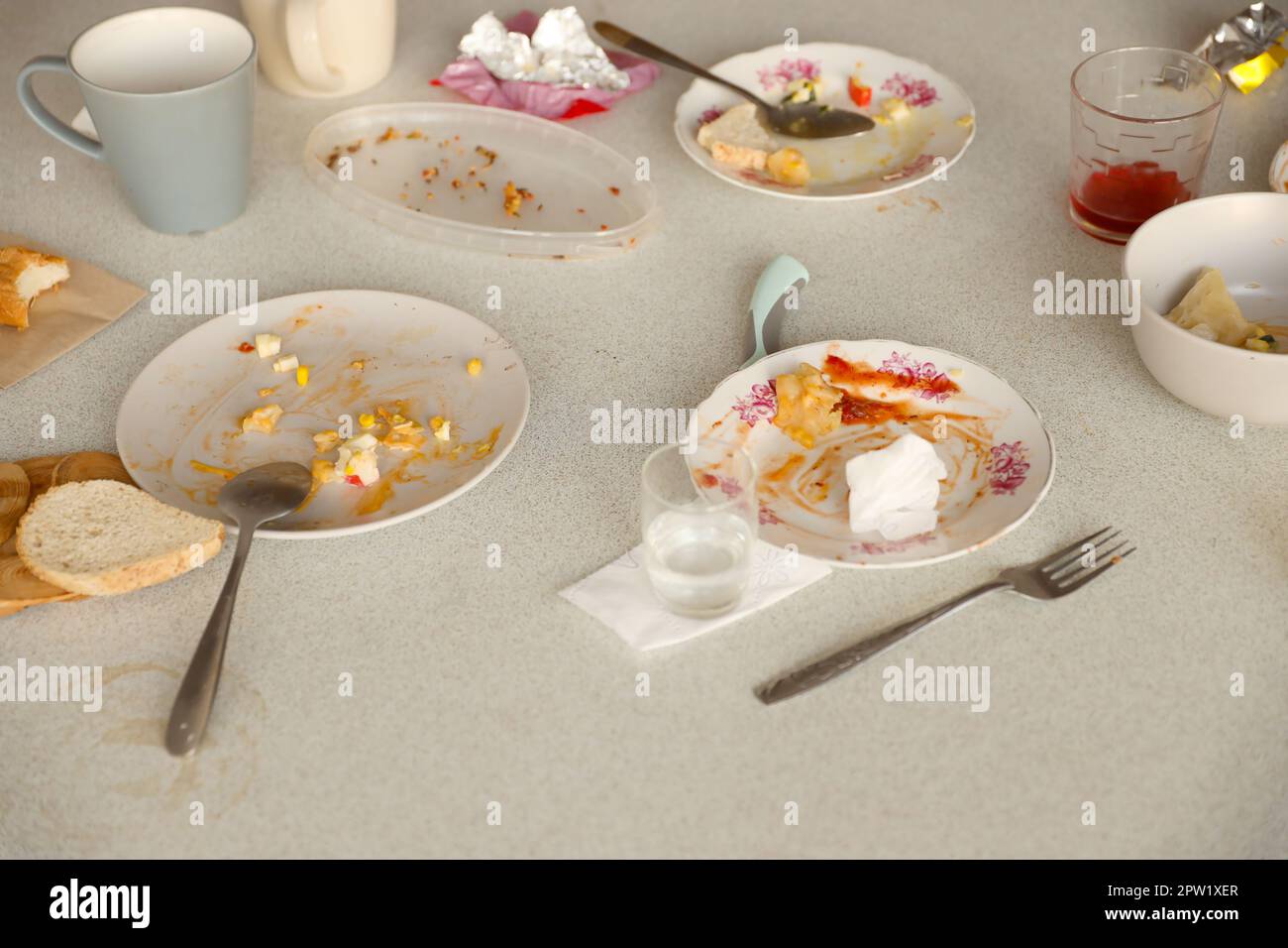 Empty dirty plates with spoons and forks on the table after meal ...