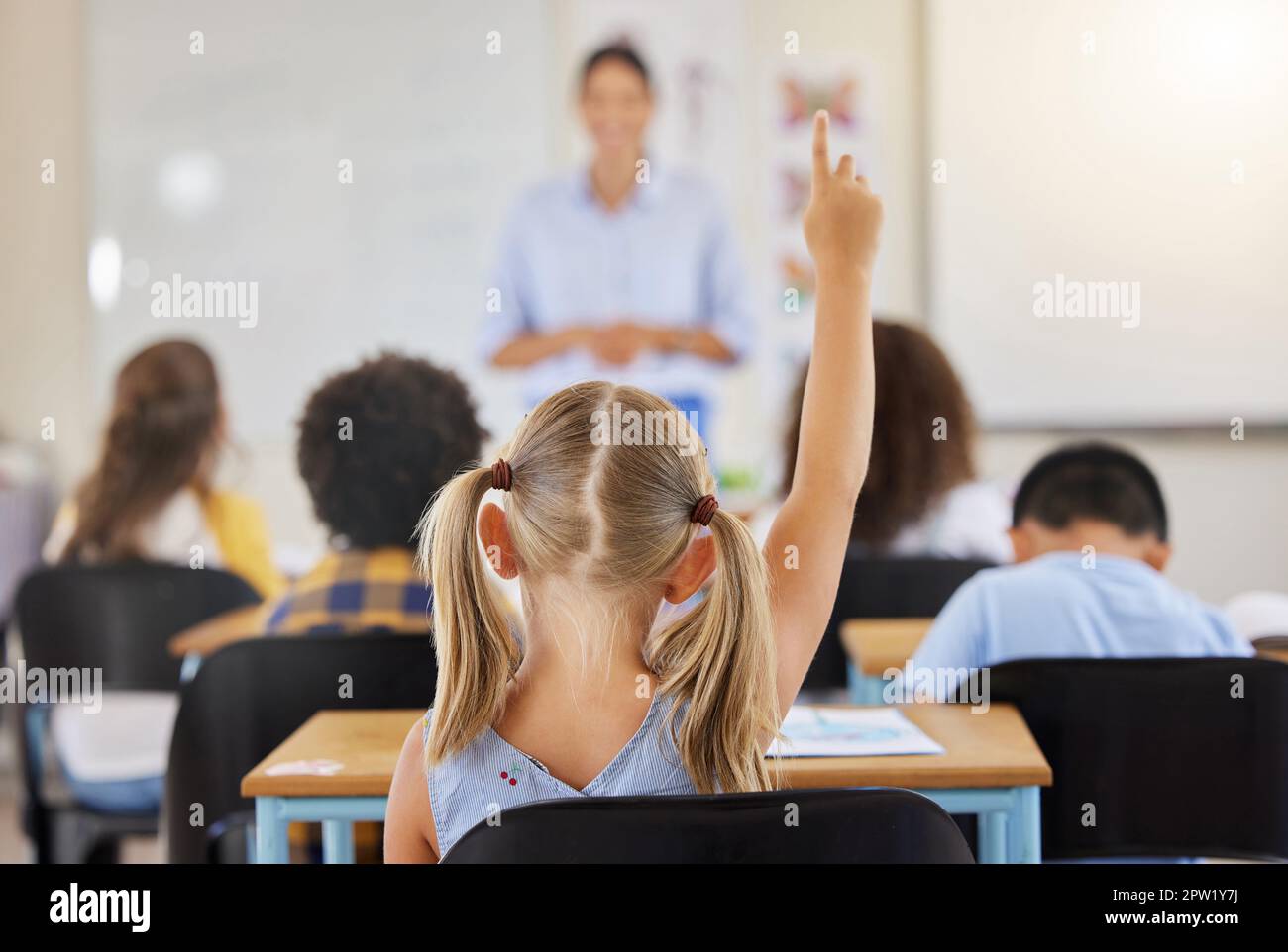 We know this one. a young woman teaching a class of school children ...