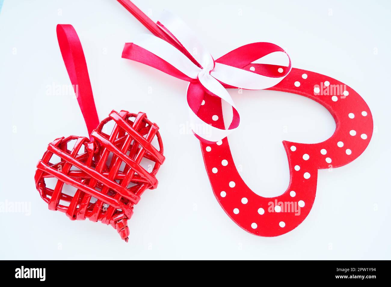 Valentine's day concept. Two red hearts. Wooden heart with white dots ...