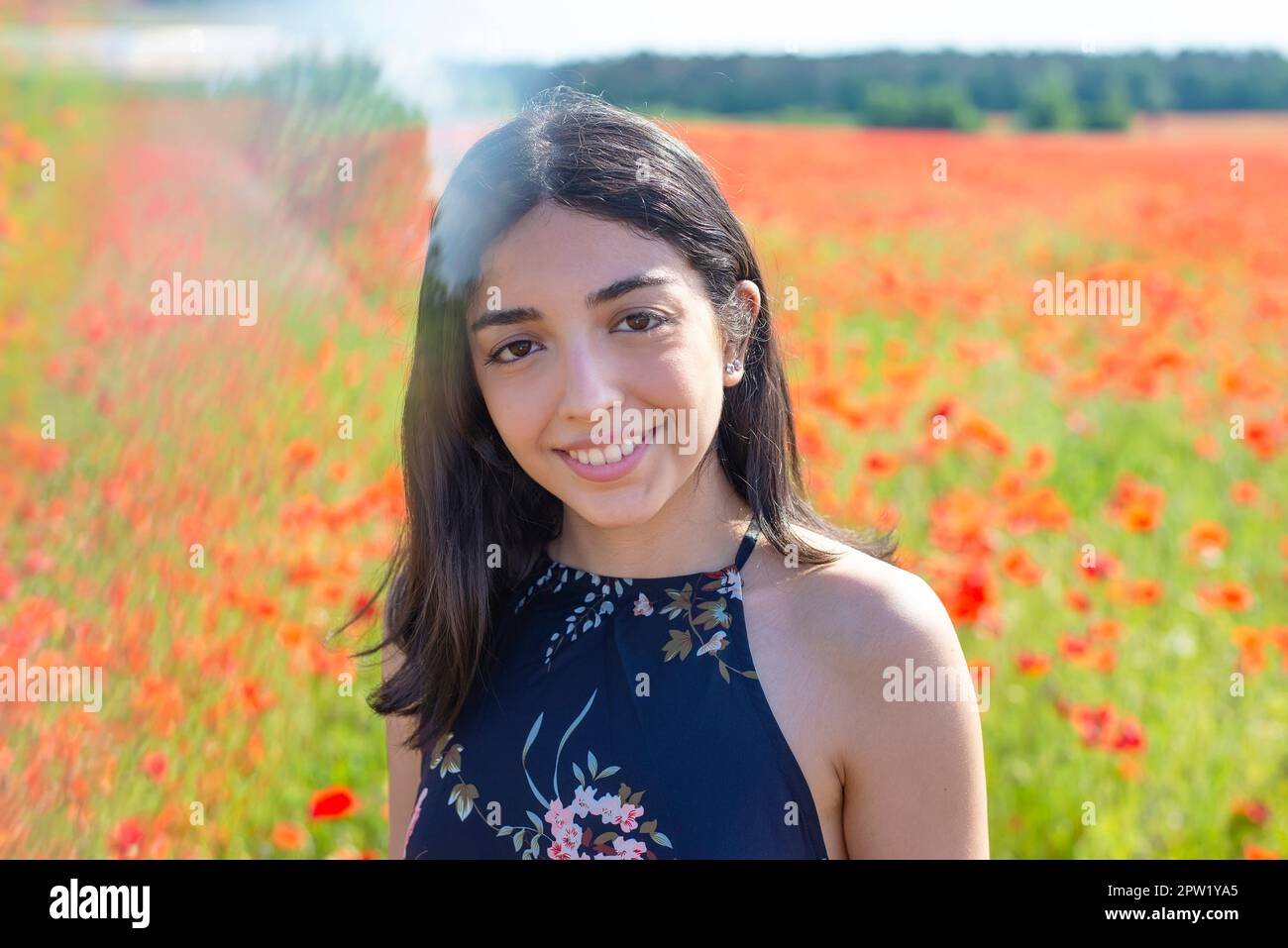laughing young woman in poppy field Stock Photo - Alamy