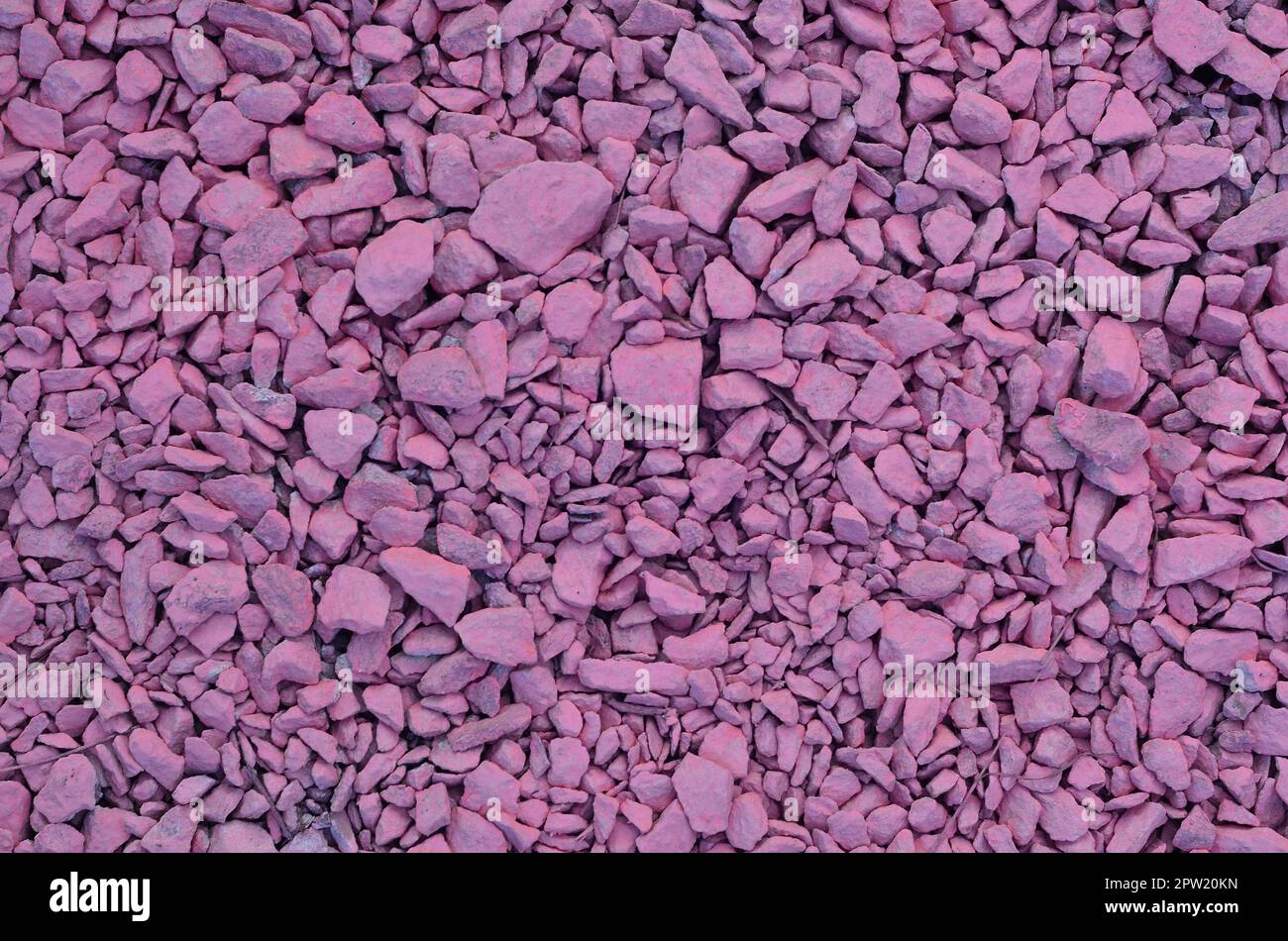 Texture from a pile of crushed stone, painted in light pink color ...