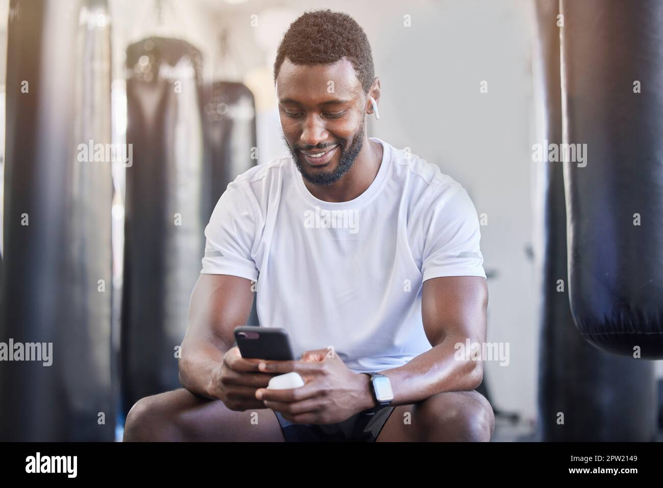 Fitness, music and phone with black man in gym for training, workout ...