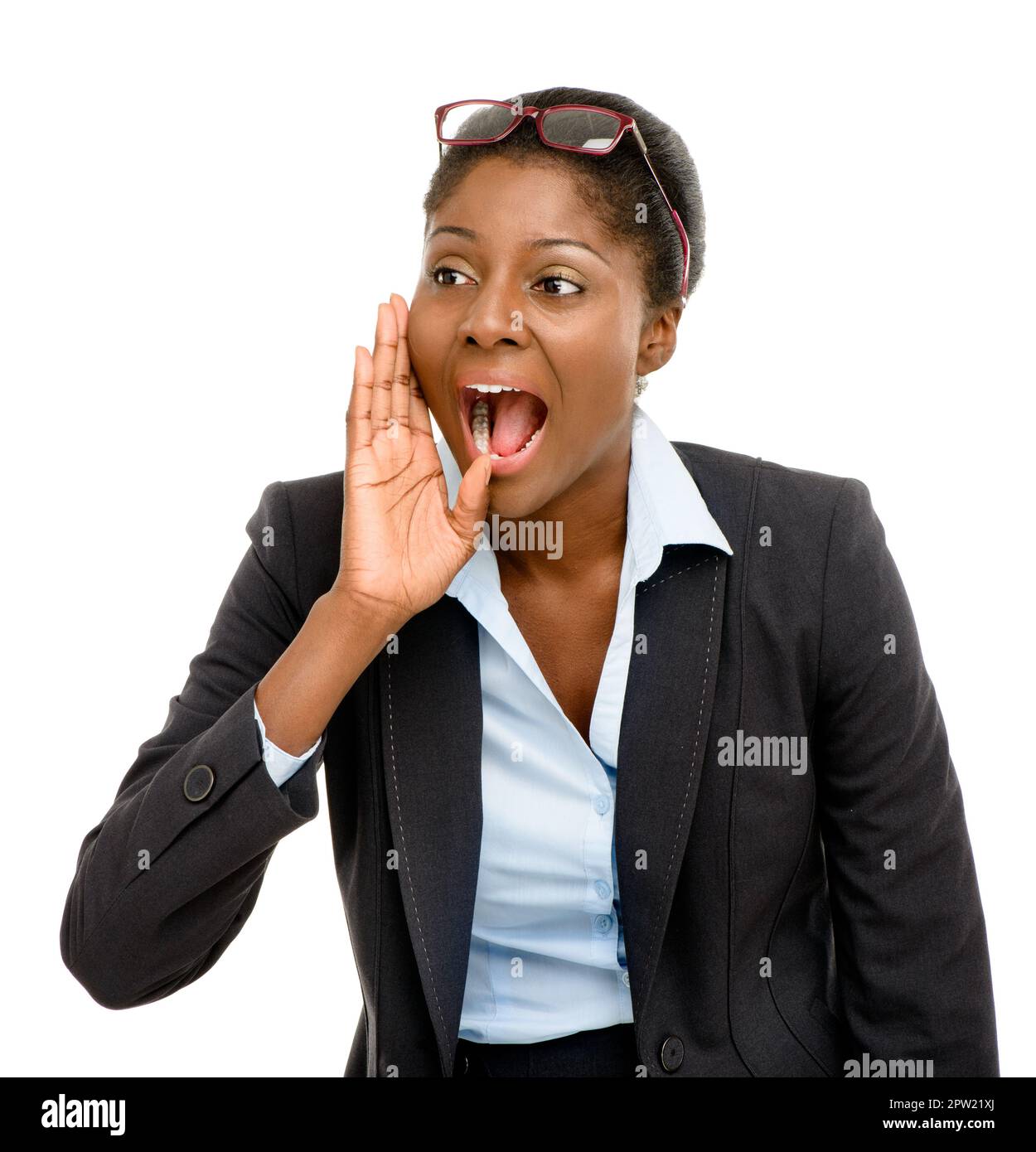 Hey, you over there. Studio shot of a young businesswoman shouting ...