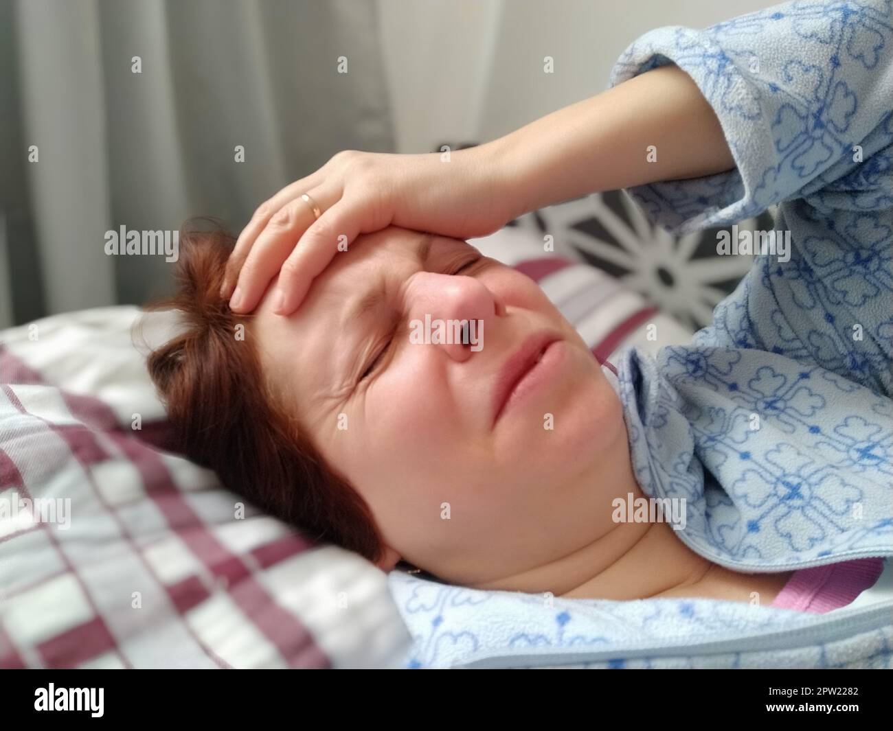 Sick woman in bed. Headache, runny nose and cold. Paleness of the face ...