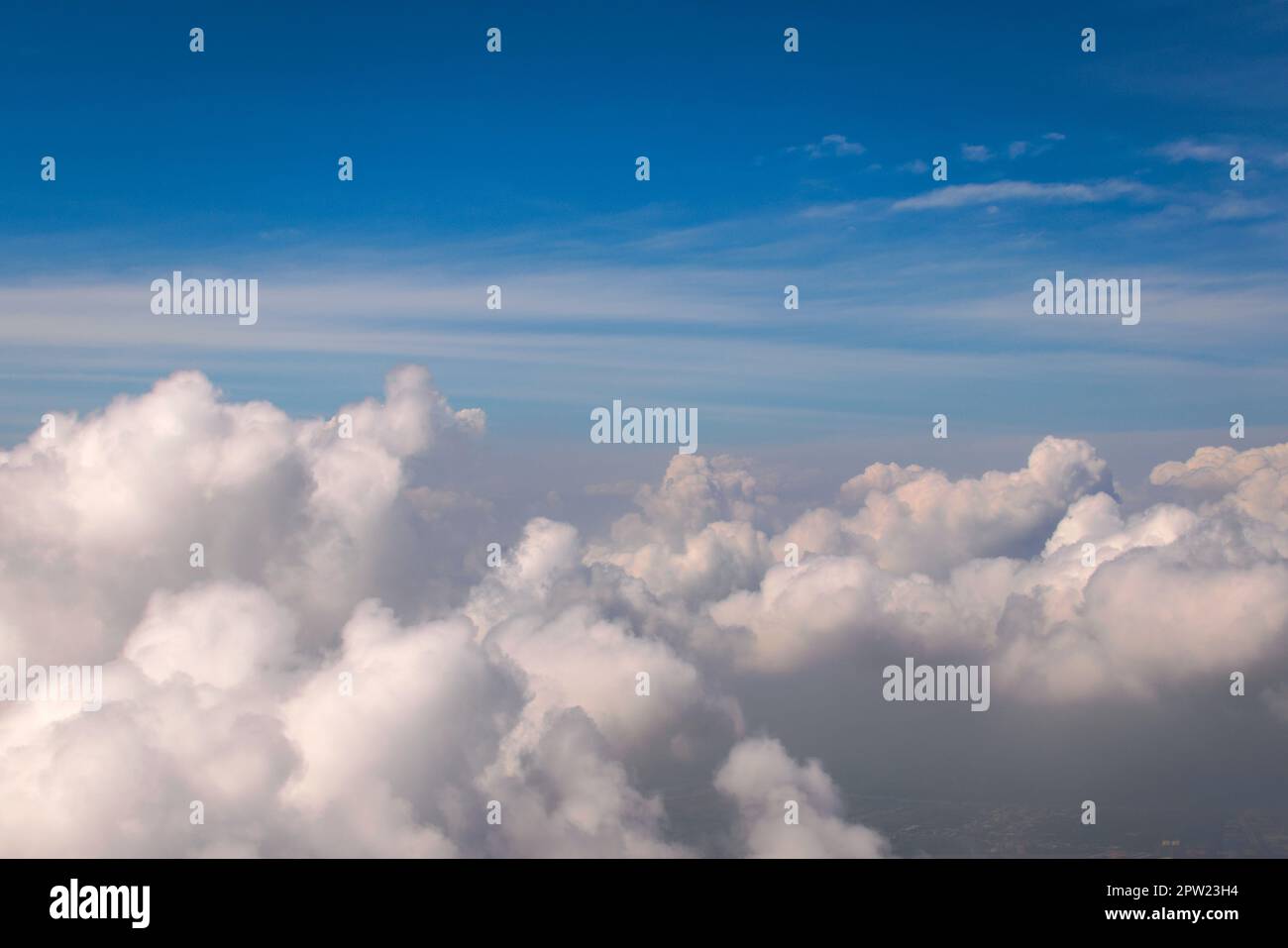 Cumulus clouds on blue sky seen from above. Cloudscape at high altitude ...