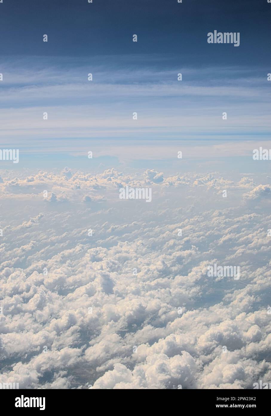 Cumulus clouds on blue sky seen from above. Cloudscape at high altitude ...