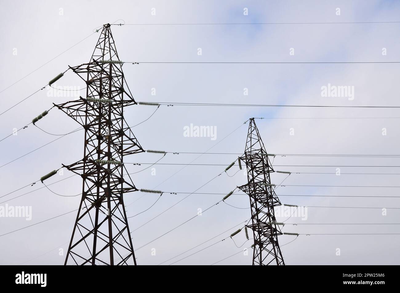 The silhouette of the electricity transmission pylon in daytime ...