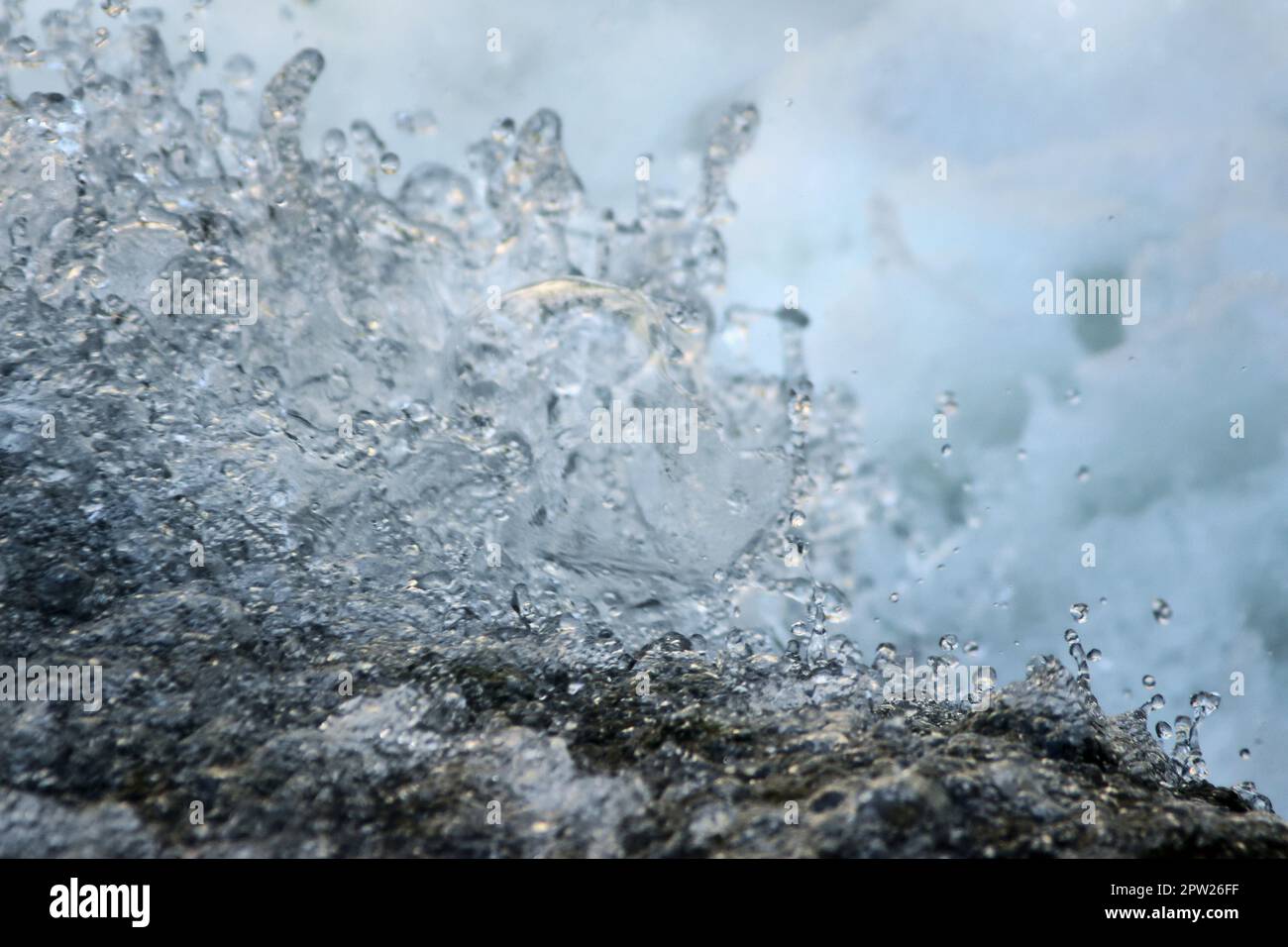 Clear, fresh stream of water splattering in a natural creek ...