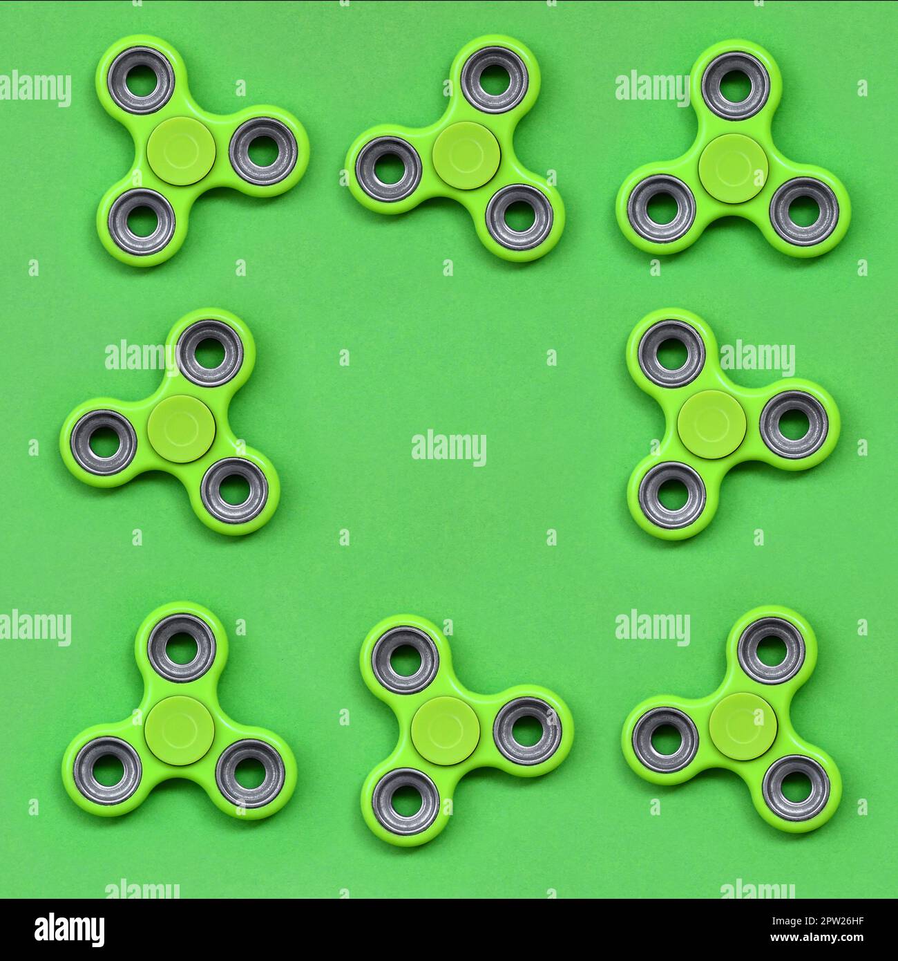 Many green fidget spinners lies on texture background of fashion pastel ...