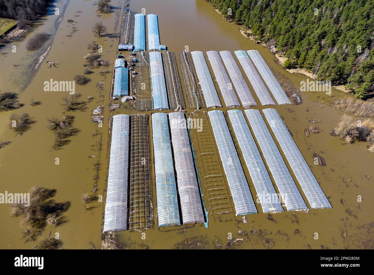 Farmlands and greenhouses flooded during the spring flood in the river ...