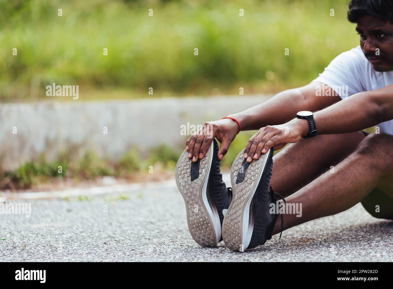 Close up Asian young athlete sport runner black man wear watch he ...