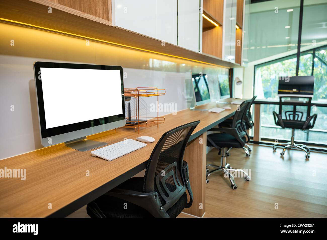 Workspace desk. Computer desktop blank screen in front of window in ...