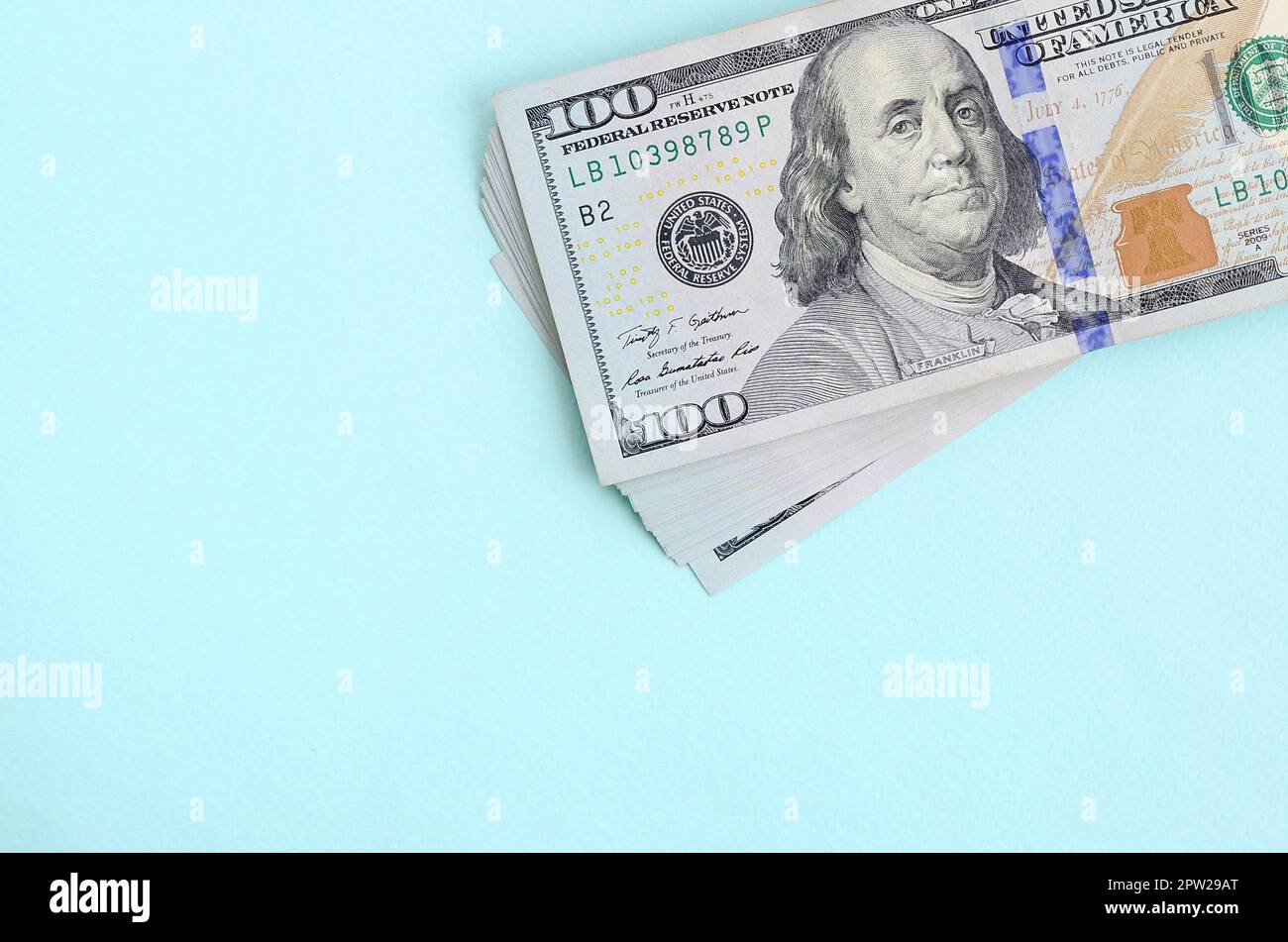 US dollar bills of a new design with a blue stripe in the middle is ...