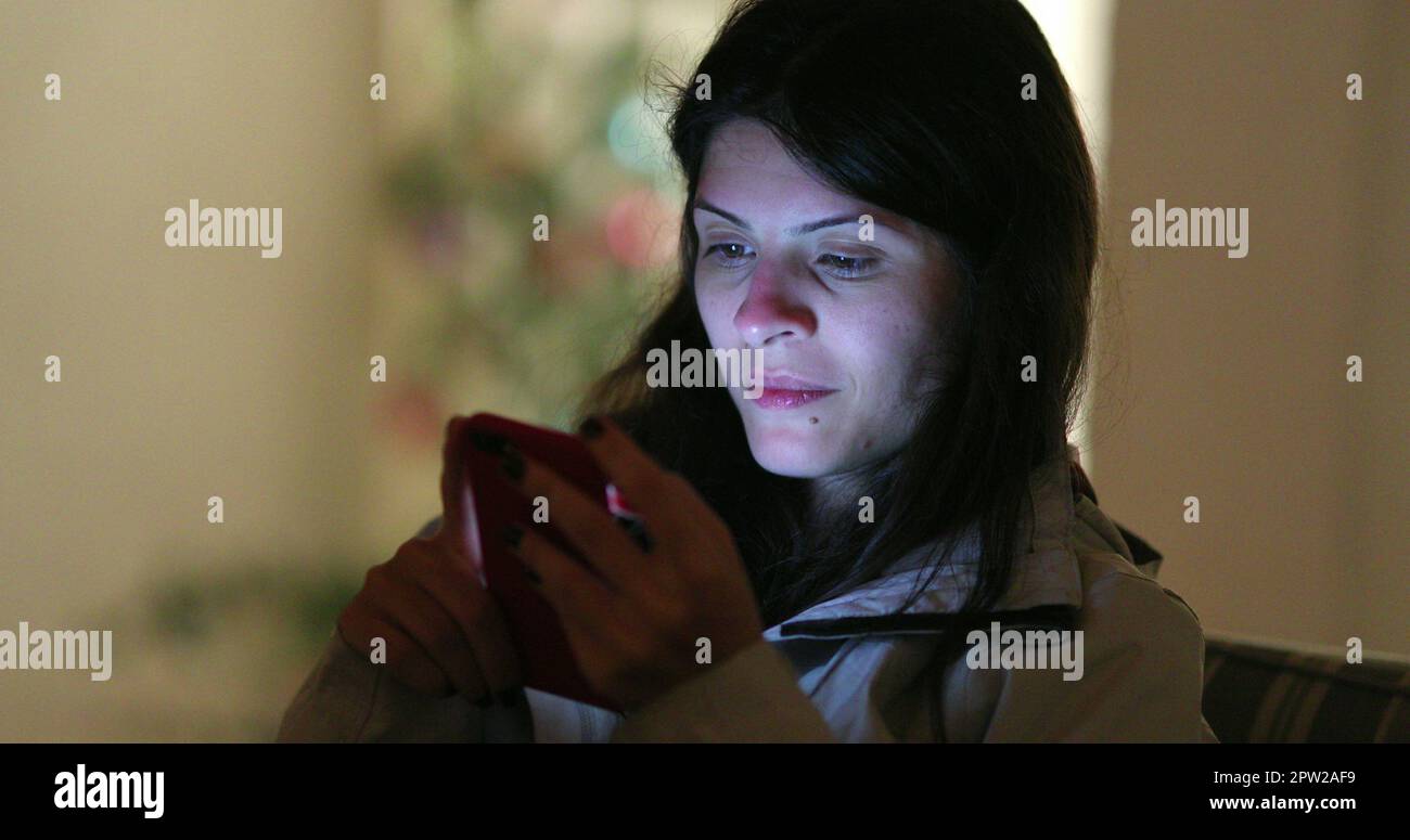 Authentic real life candid woman using smartphone device at night Stock ...