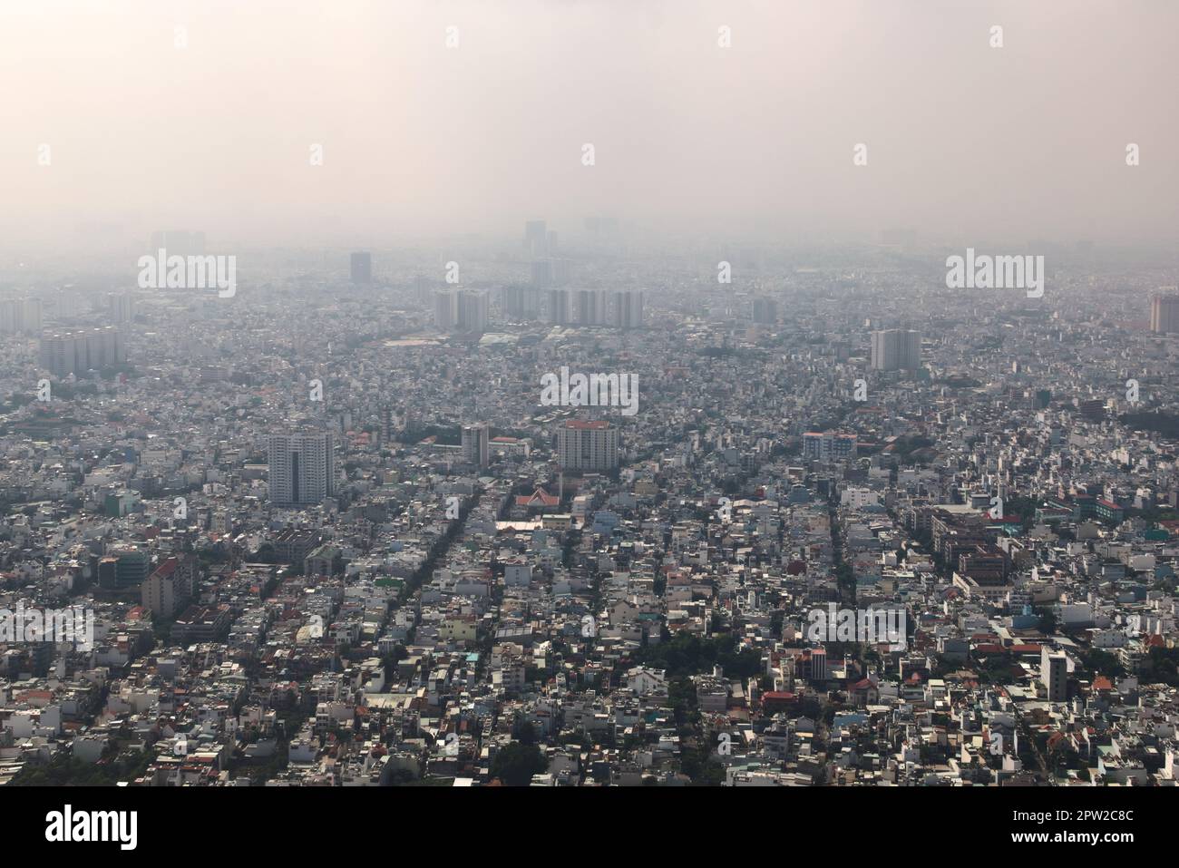 Dense air pollution and smog over Saigon, Vietnam (Ho chi Minh City). Overpopulated city, urban ...