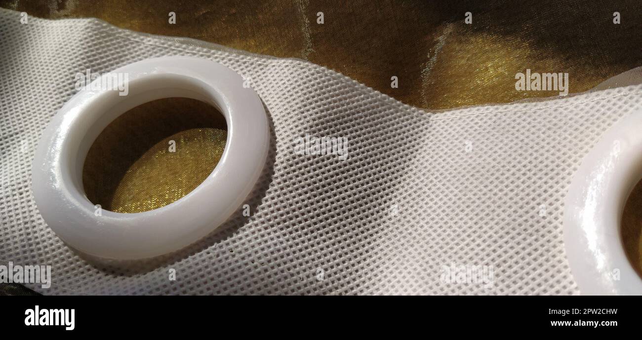 Plastic rings for attaching the fabric to the curtain rod. White ...