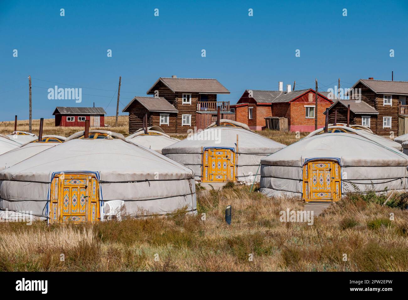 Yurts, wooden barracks and brick houses in a vacation camp in the ...
