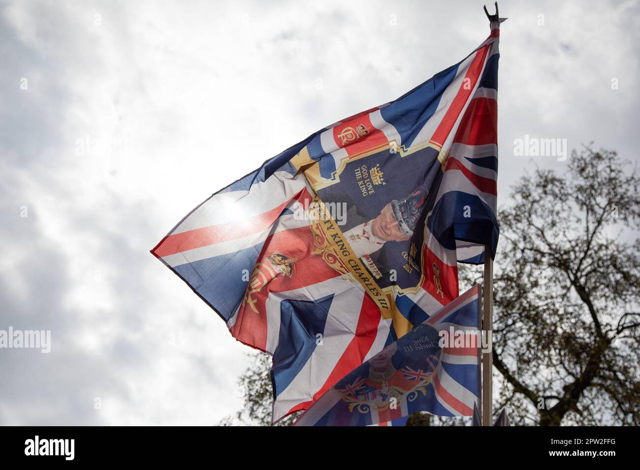London, UK. 28th Apr 2023. A flag featuring the King flutters in the ...