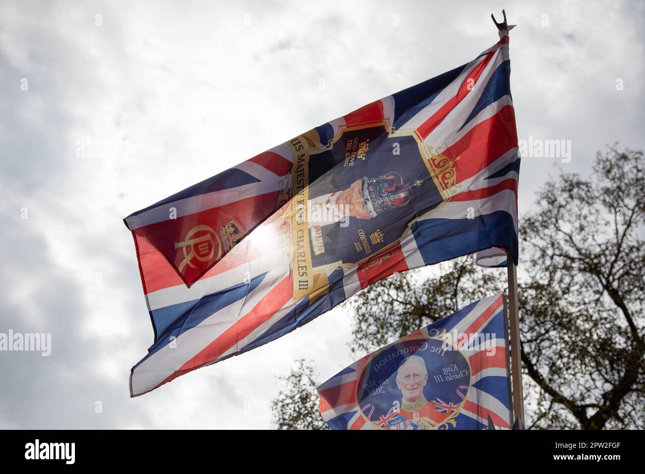 London, UK. 28th Apr 2023. A flag featuring the King flutters in the ...