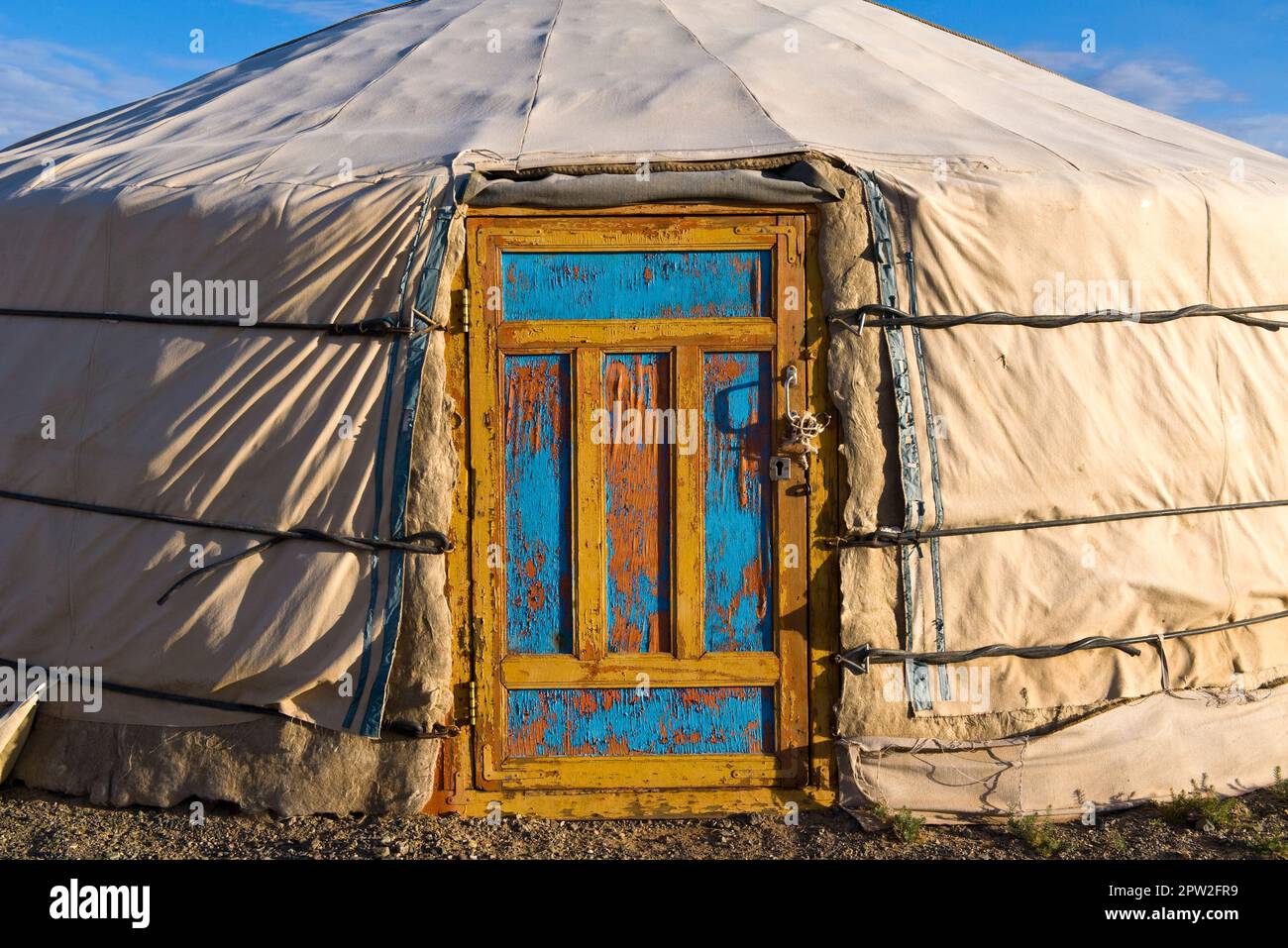 A Mongolian yurt with closed wooden door, the dwelling of the native ...