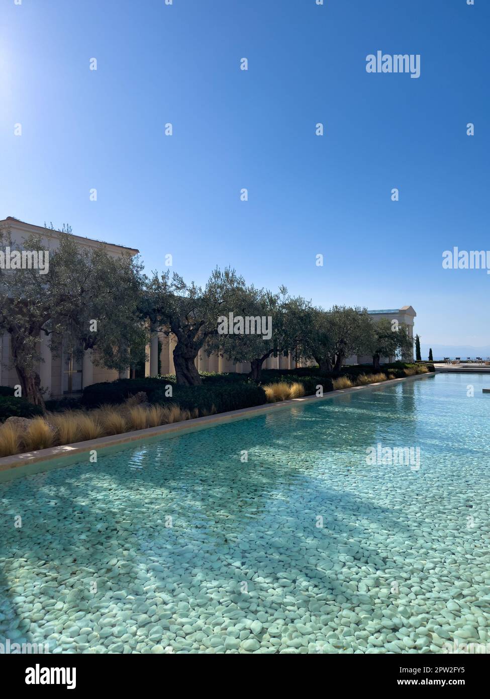 Long pool with clear water and a pebbly bottom near the terraces with ...