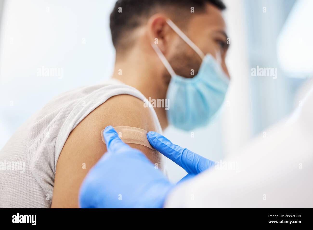 Shot of an unrecognizable doctor putting a band-aid on her patient ...