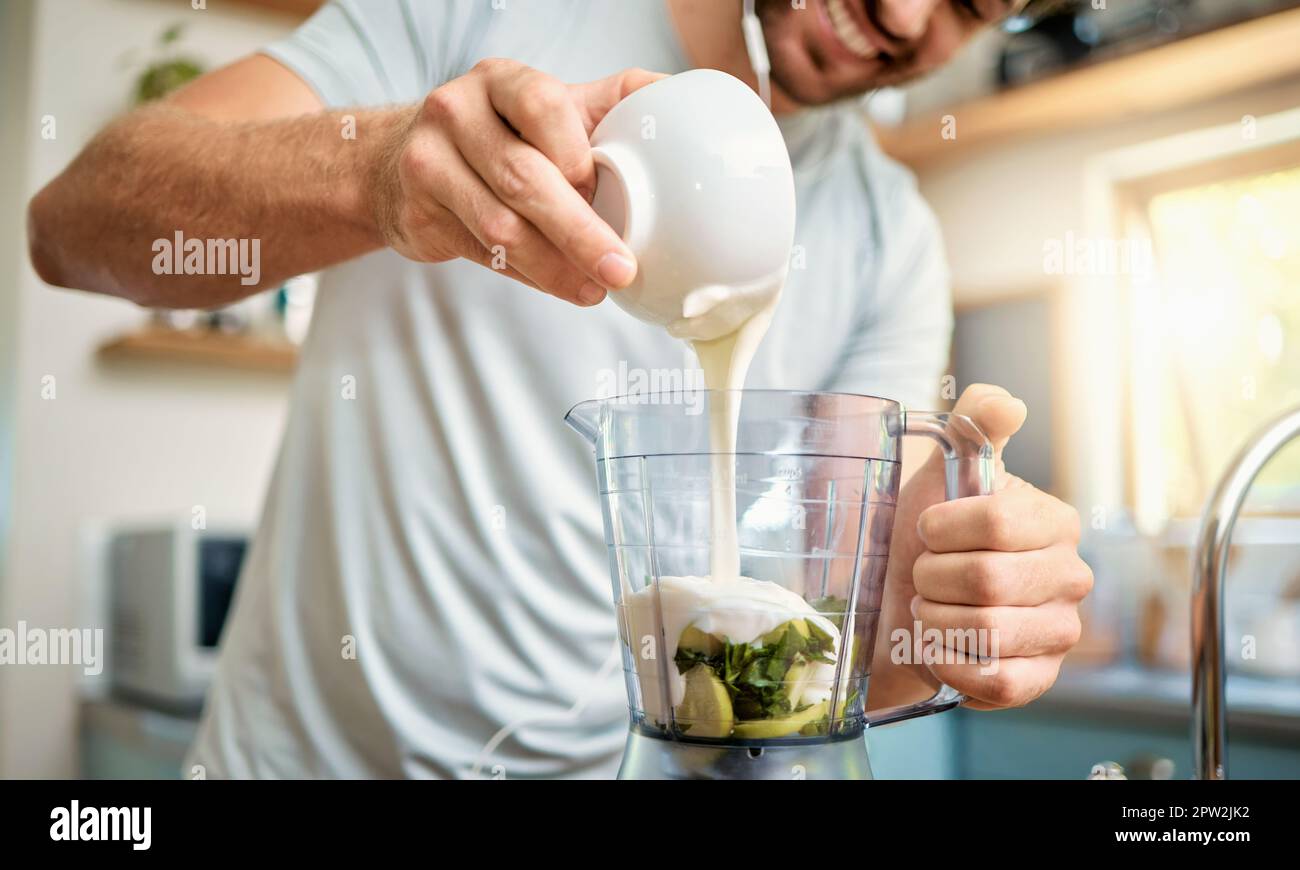 Closeup of one caucasian man pouring yoghurt into blender for healthy ...