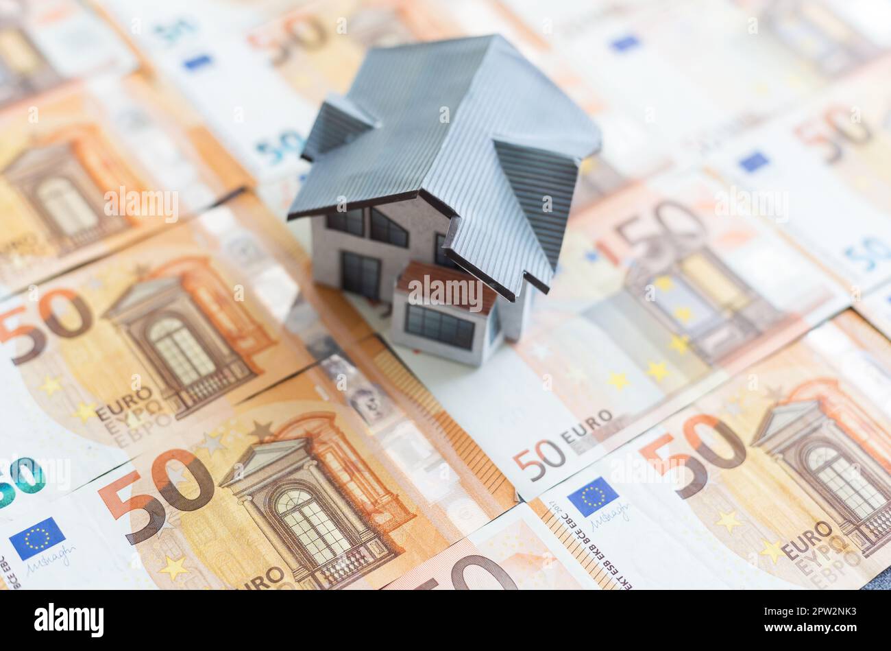 Building cost (construction cost) concept. Model of house under ...