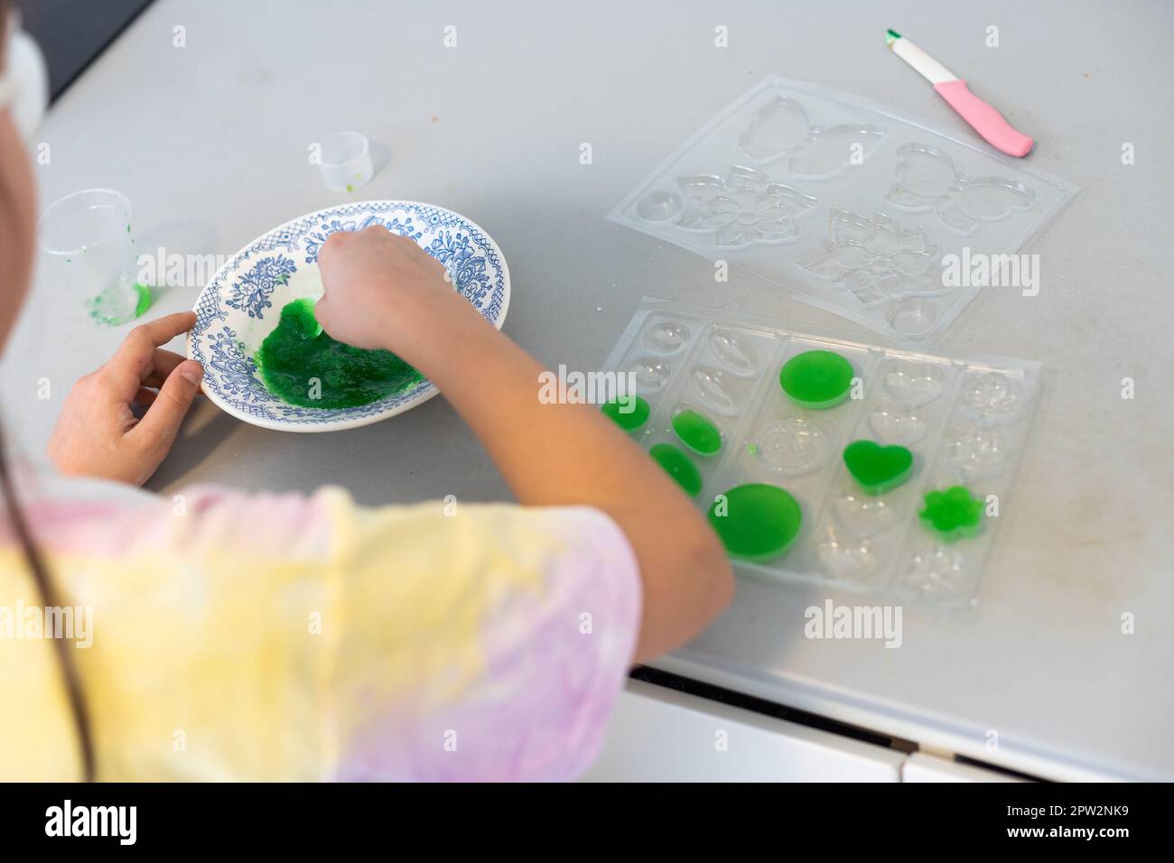 Enthusiastic little girl doing home science project, having a eureka ...