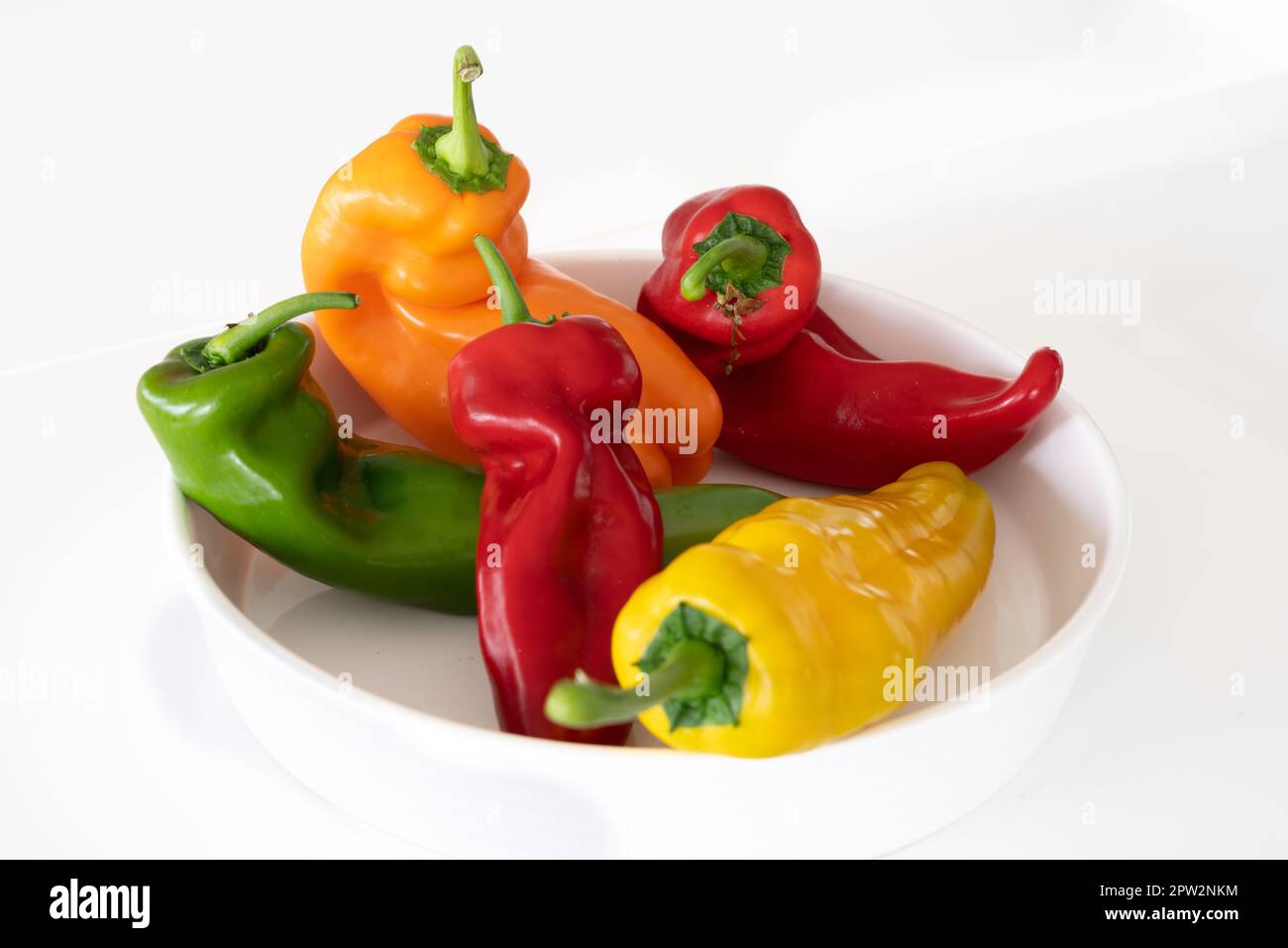 Capsicum unusually shaped isolated in white bowl Stock Photo - Alamy