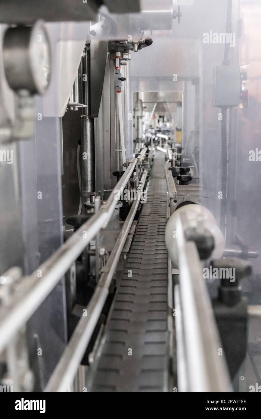 Industrial bottling machine at modern wine factory in Italy, close up ...