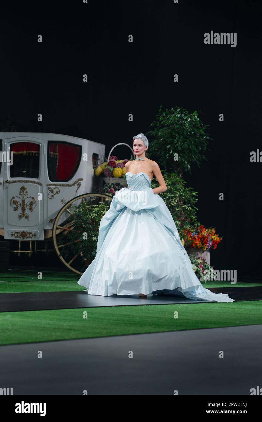 Fashion model in designers dress walking on runway decorated with Royal ...