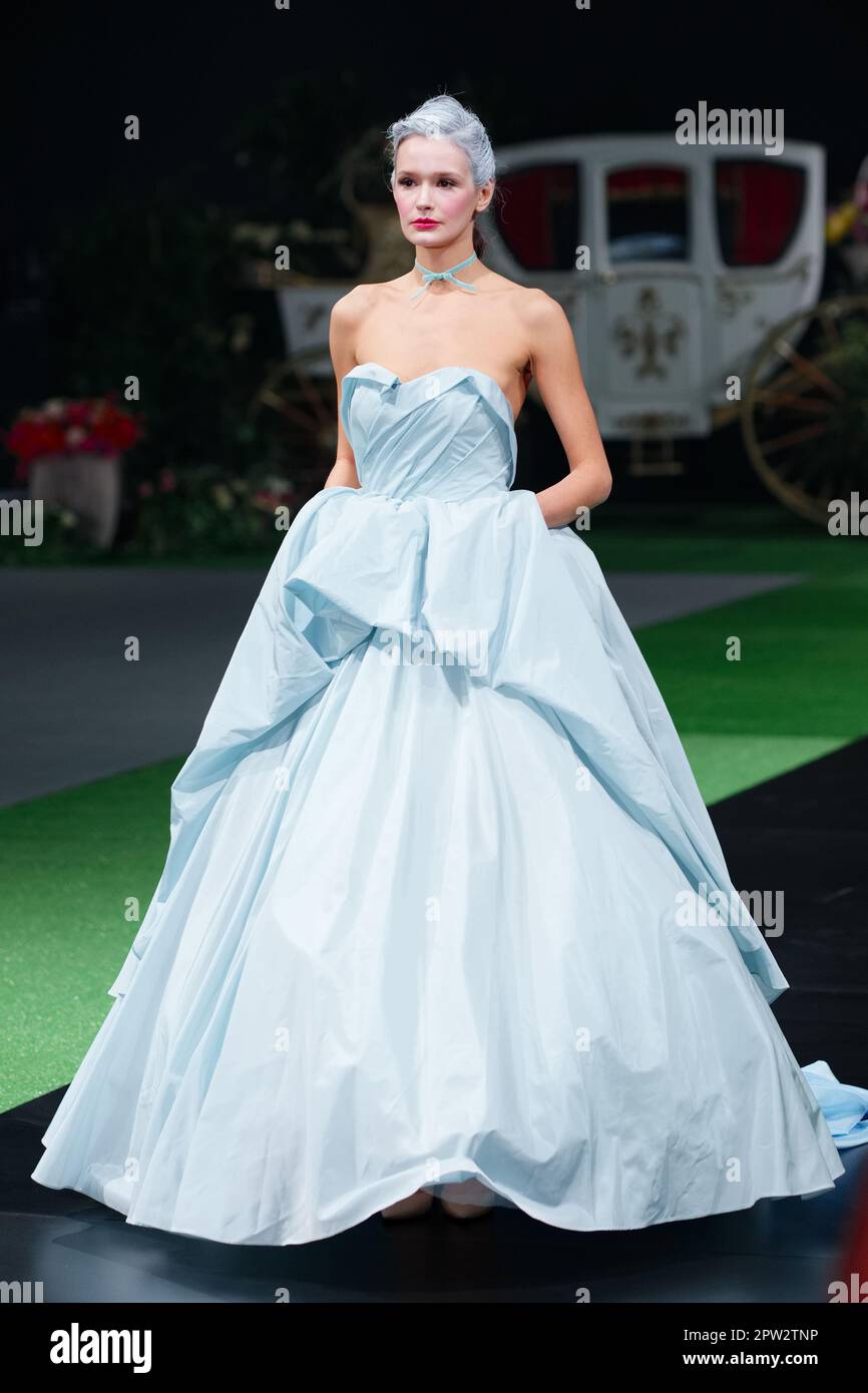 Fashion model in long designers dress walking on runway Stock Photo - Alamy