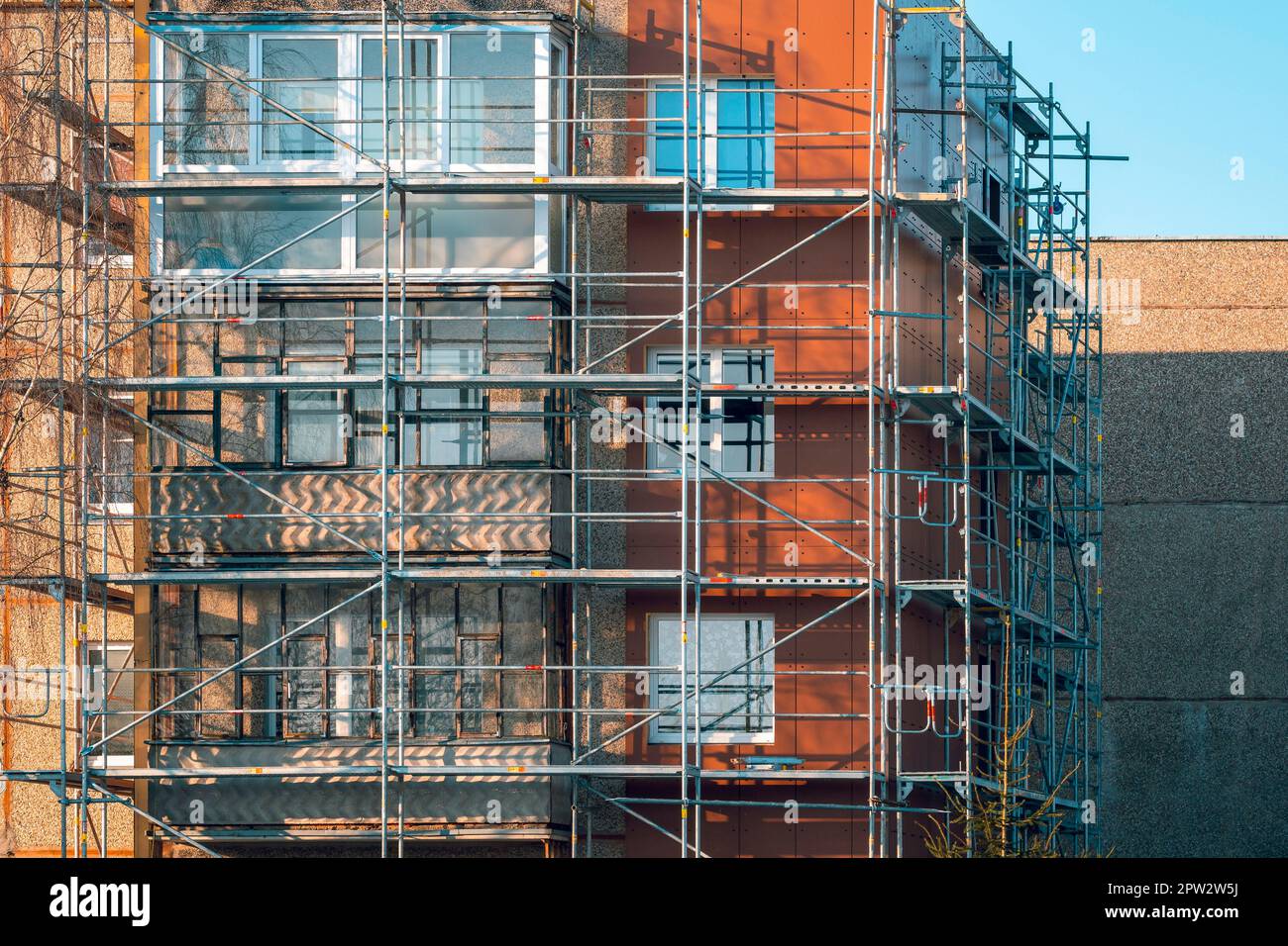 Tall building under construction with scaffolds. Construction site ...
