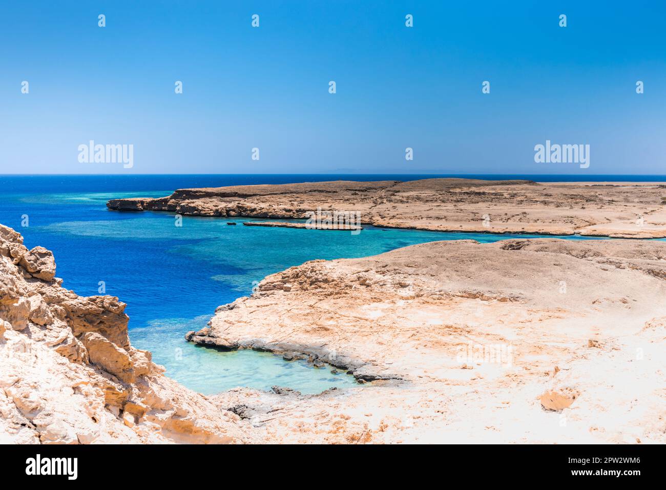Sandy and rocky coast with blue color of water. Desolate beach on the ...