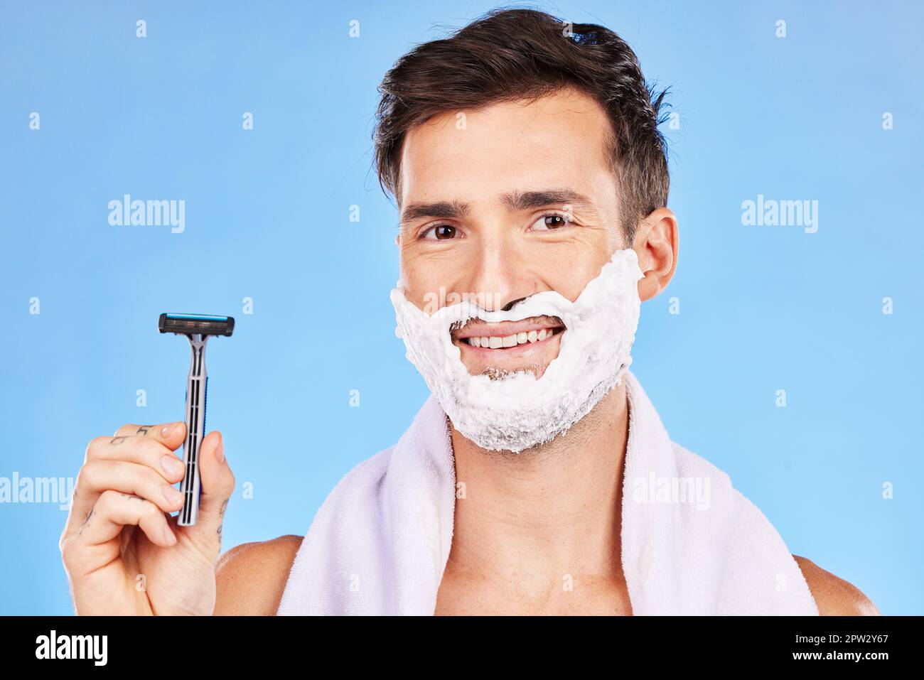 Man, razor and shaving with cream, happy and skincare while grooming beard, morning and cosmetic ...