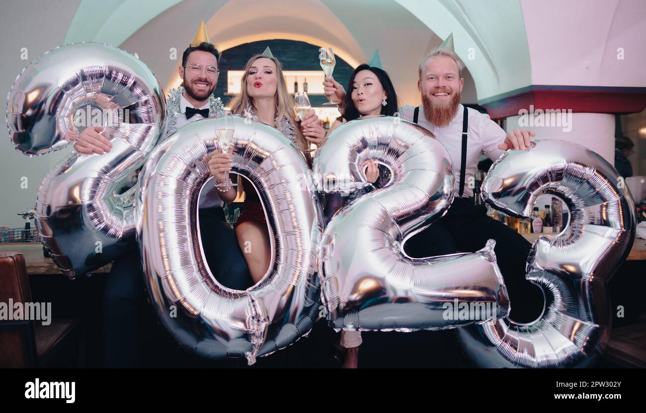 Group of party people celebrating the arrival of 2023, men and women ...
