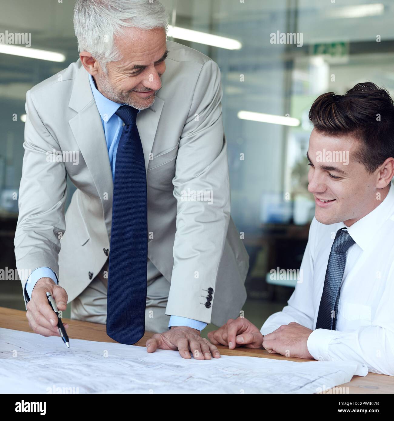 Designing an architectural masterpiece. two architects looking at ...