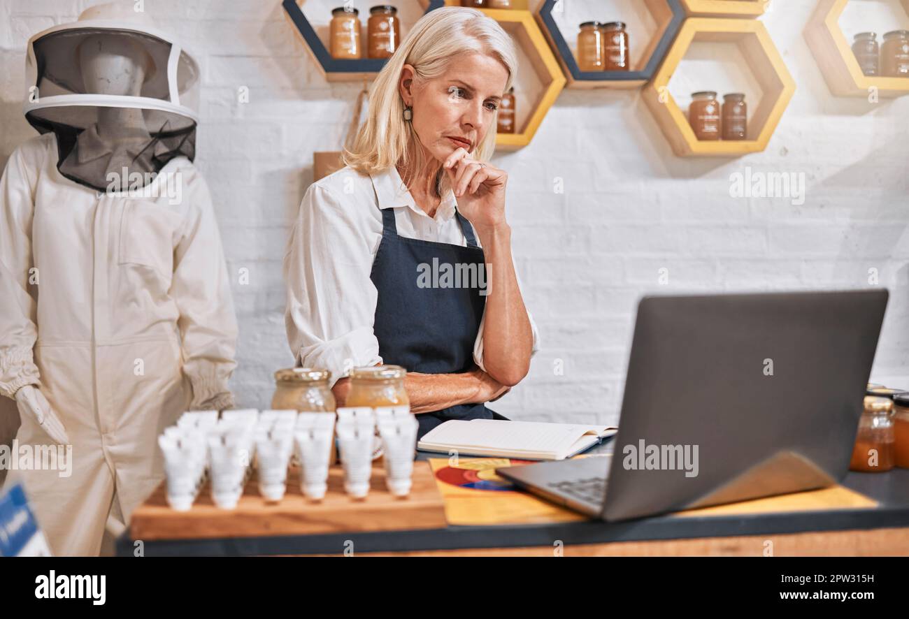 Shop, stress and anxiety of owner at laptop with inflation, debt or ...