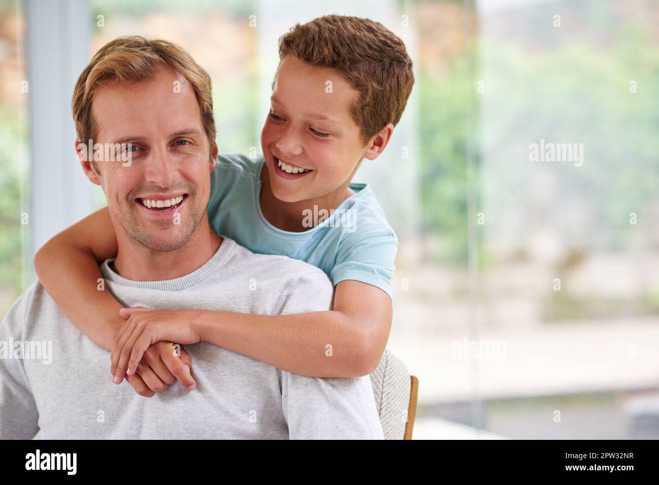 We always have a laugh together. Portrait of boy hugging his father ...