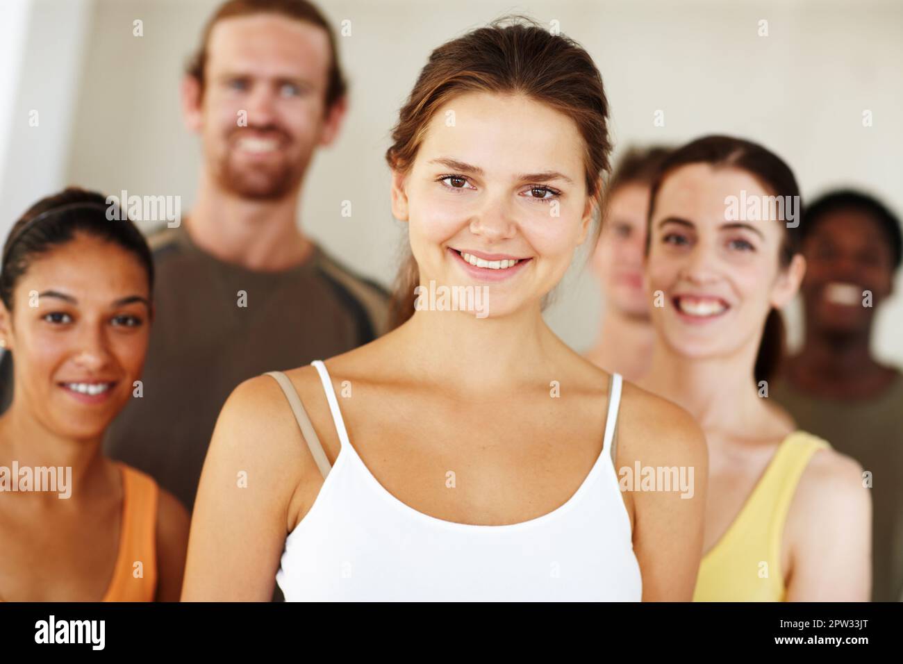 Keeping fit with yoga. Portrait of a happy group of yoga enthusiasts ...