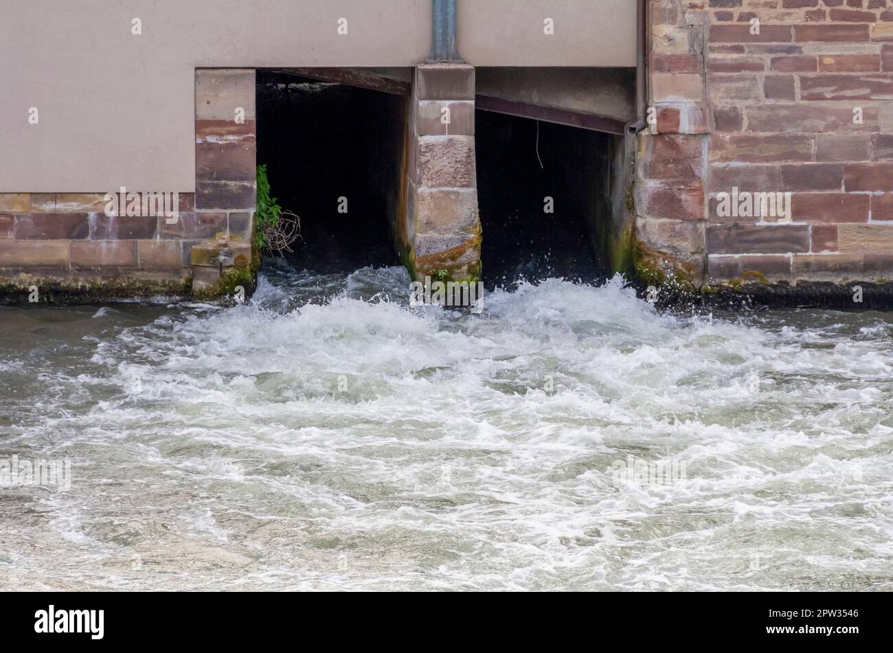 Outdoor scenery showing a wall with watergate and water Stock Photo - Alamy
